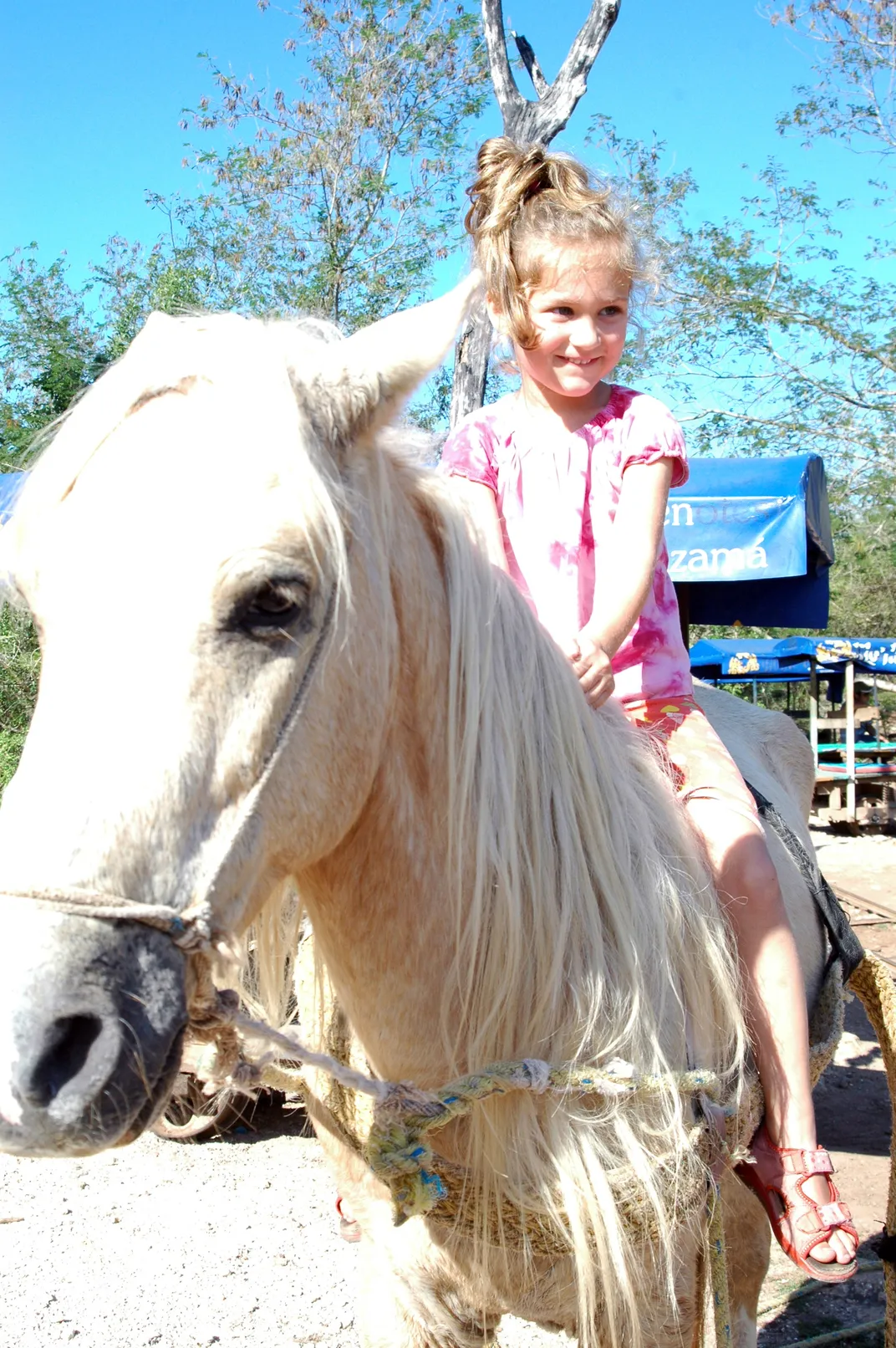 My daughter Anneki very happy riding a horse in Cuzama, a complex of 3 ...