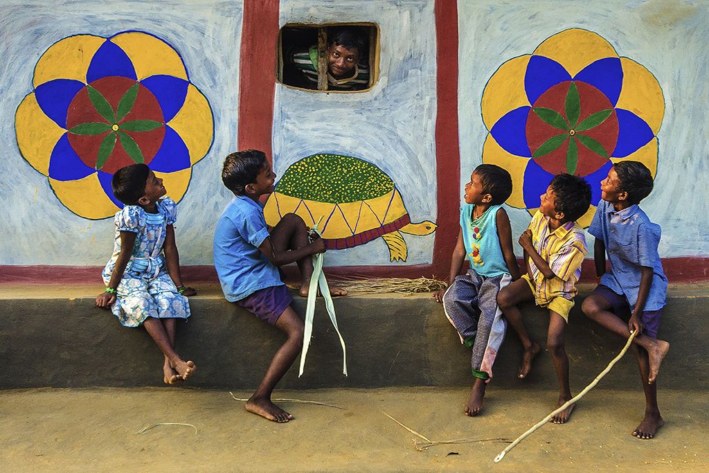 Tribal children are playing on the courtyard of their beautifully ...