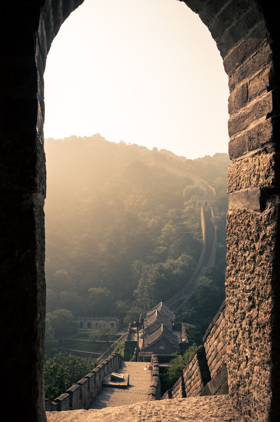 Looking out of one of the turrets along the Great Wall as the sun comes ...