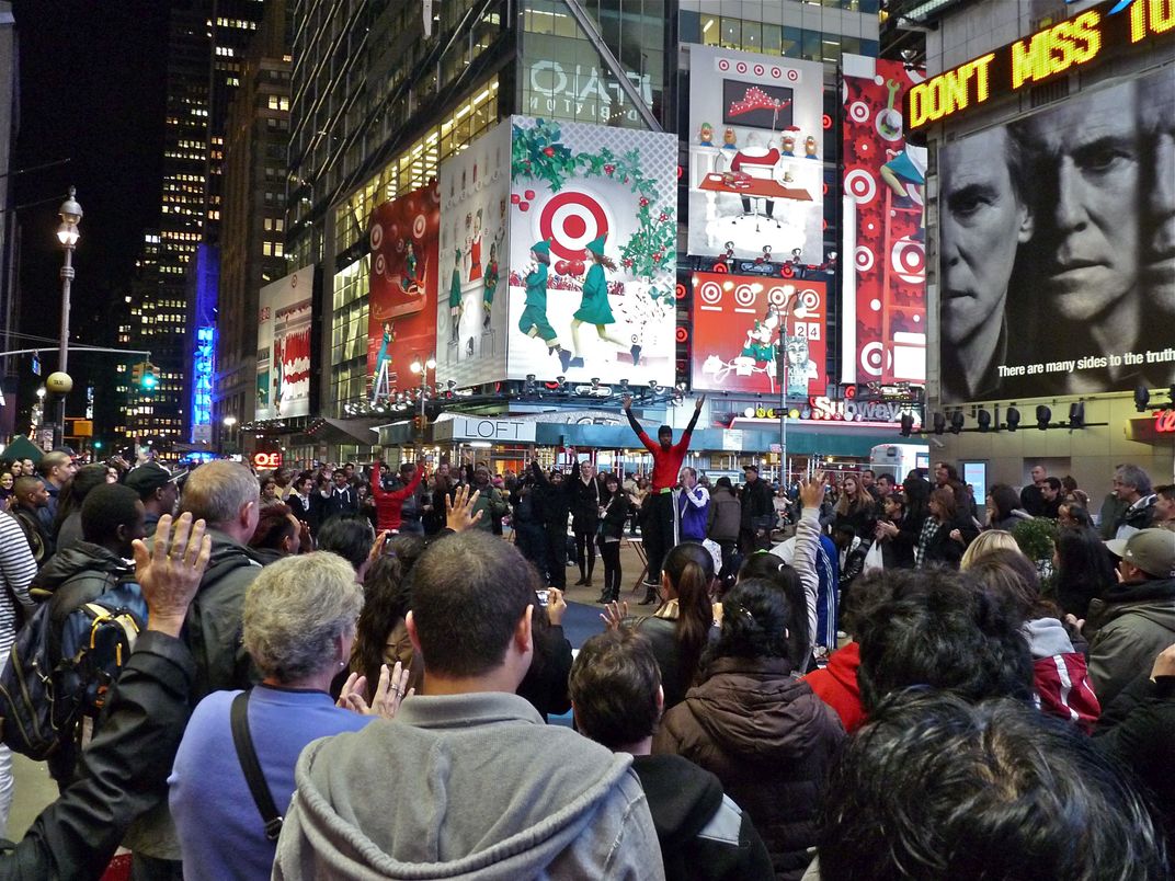 Street entertainers gather a crowd during the holiday season in NYC's ...