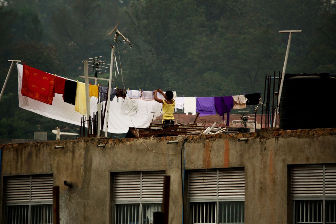 A woman hanging laundry on a rooftop. | Smithsonian Photo Contest ...