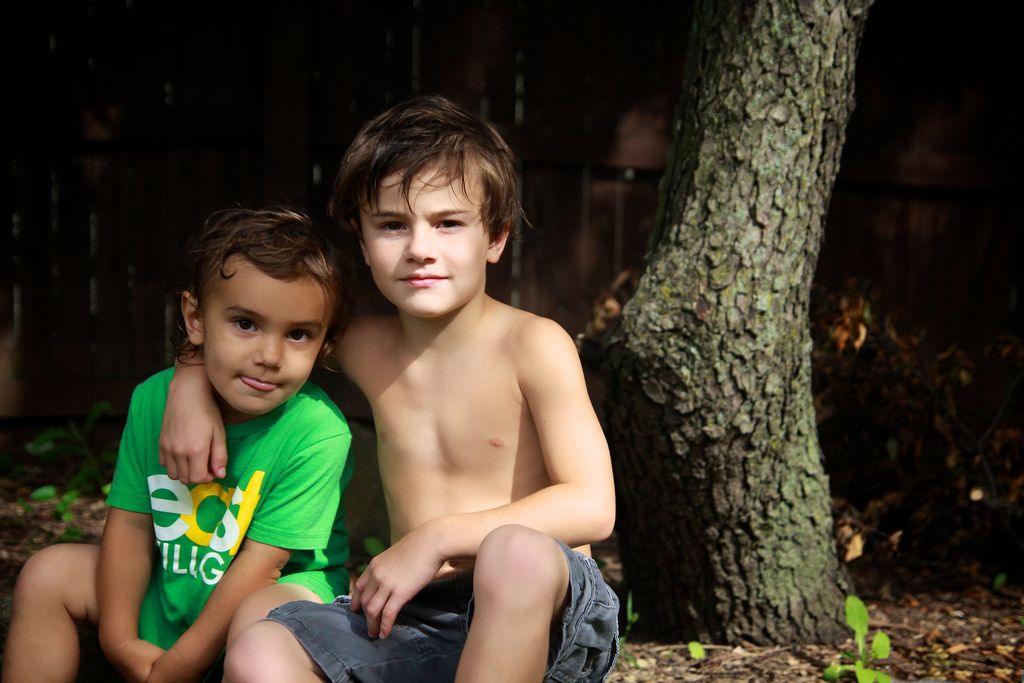 Two brothers sit down for a photo on a nice summer afternoon. They ...