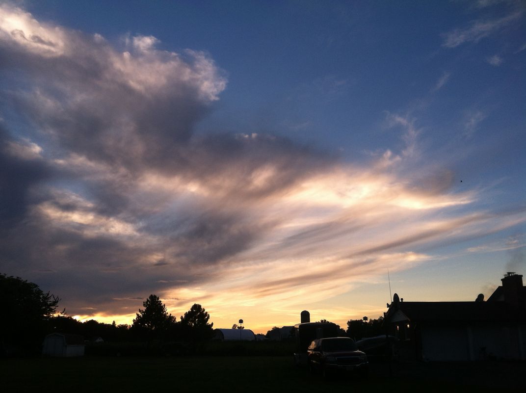 A beautiful view of the sky as the sun is setting on a summer day ...