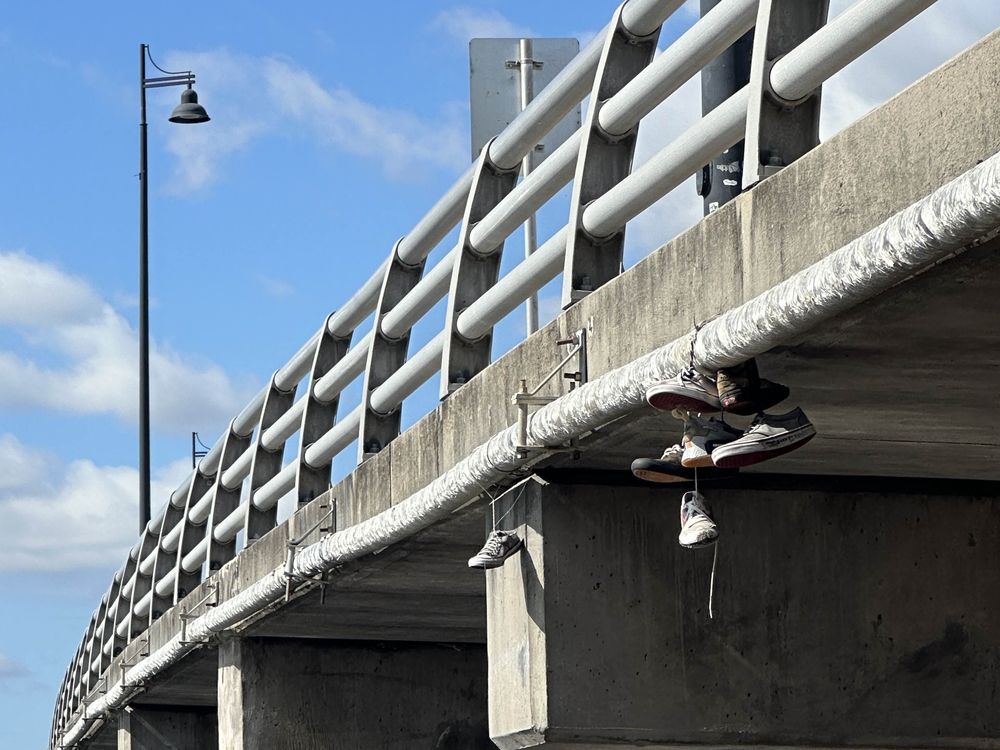A bunch of shoes hanging off a bridge after Hurricane Milton ...