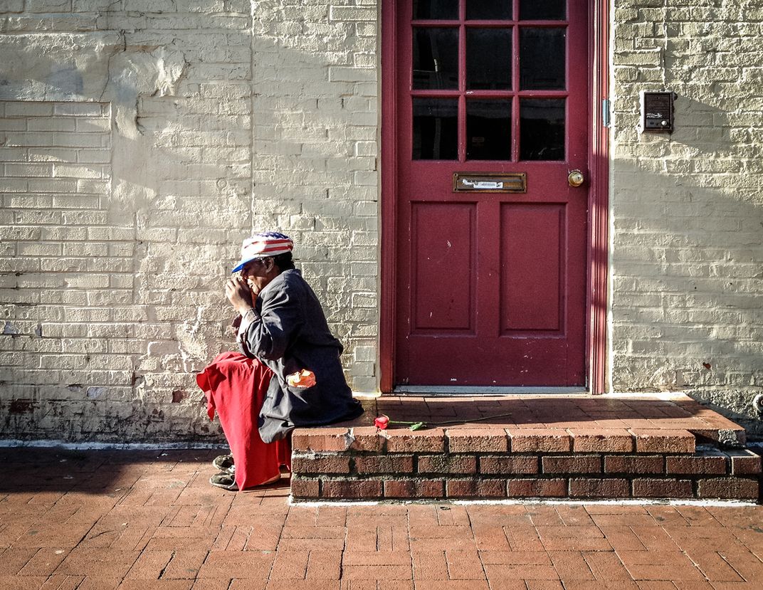 A destitute woman in Washington D.C.'s Chinatown cries while facing the ...