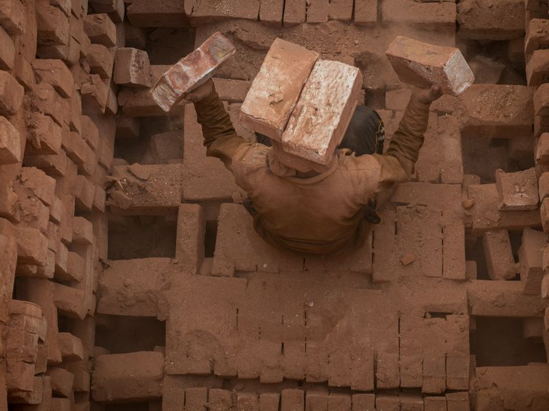 Man placing bricks on his head | Smithsonian Photo Contest ...