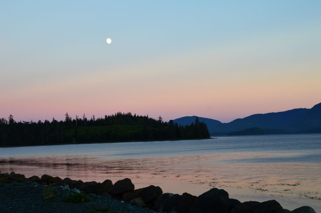 three-quarter moon over Alaskan bay shoreline | Smithsonian Photo ...