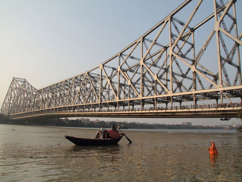 The river Ganges flows through the city of Kolkata, a worshiper in the ...