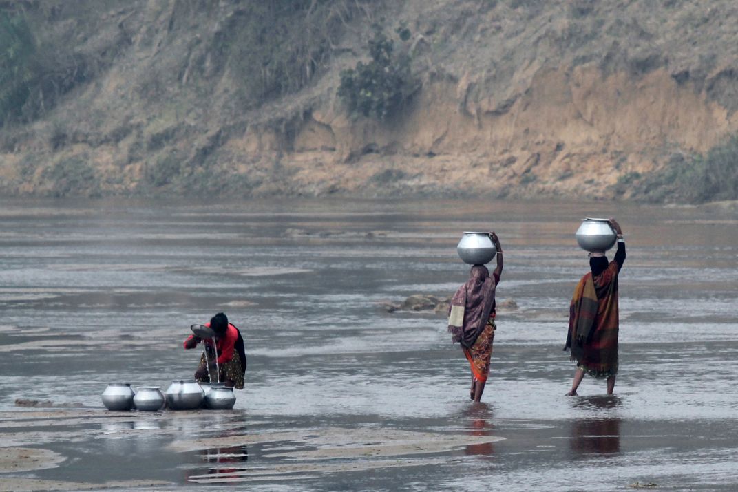Villagers collect water from almost dry river | Smithsonian Photo ...