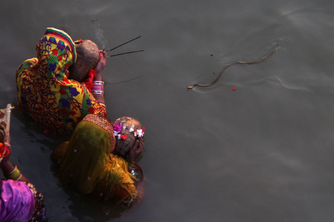 SHIVA-SNAKE- IN THE CHAT PUJA(WORSHIP) ,THE WOMEN OFFERING THEIR PRAY ...