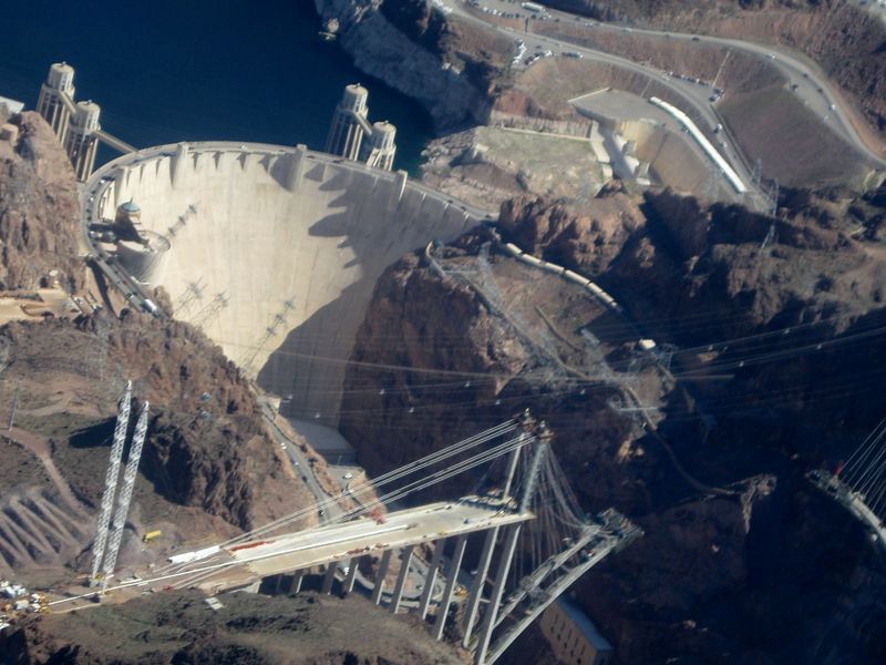 Flight over the Hoover dam capturing the new bridge construction ...