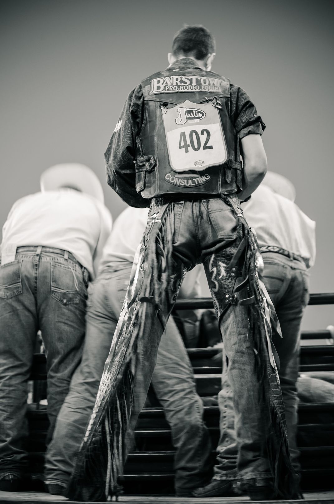 A Cowboy stands awaiting his final ride as the rodeo crew attempt to ...