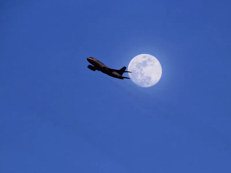 airplane flying across a full moon | Smithsonian Photo Contest ...