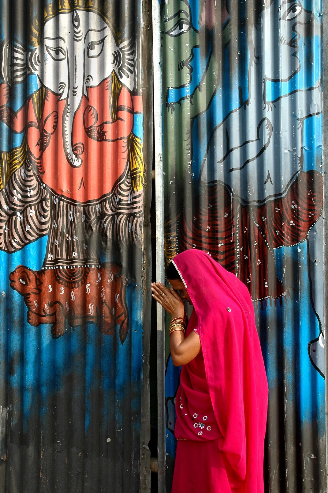 A Lady is doing Pranam in the Morning to the Picture of Lord Ganesh ...