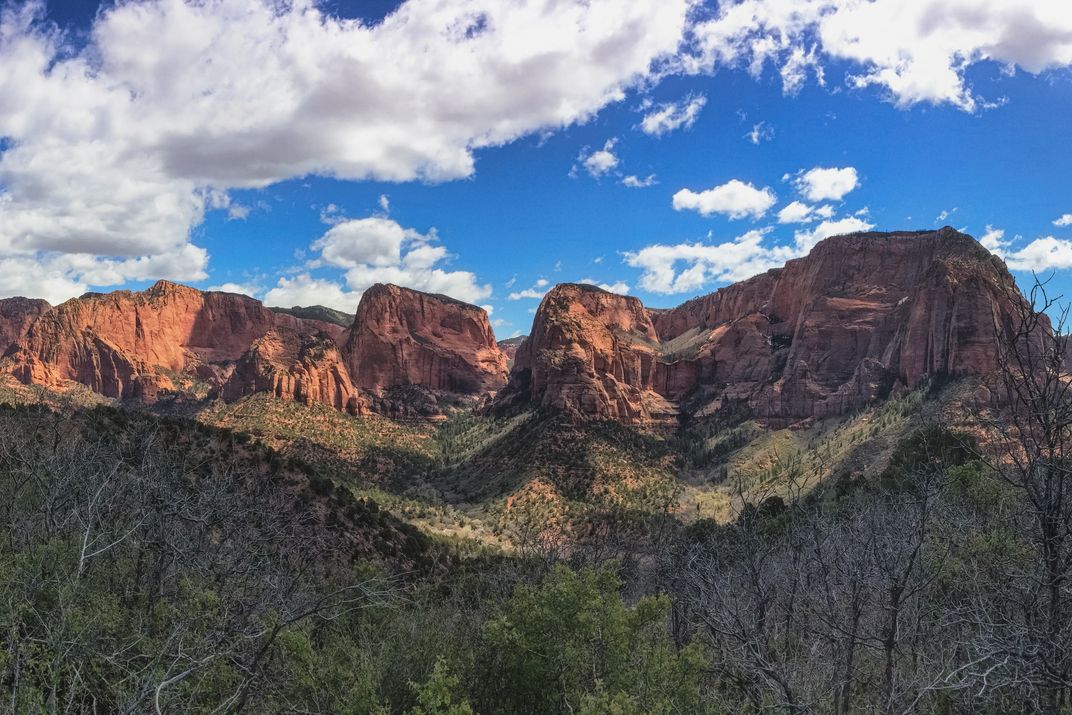 Clouds in a blue sky billowing over Zion National Park in Utah ...