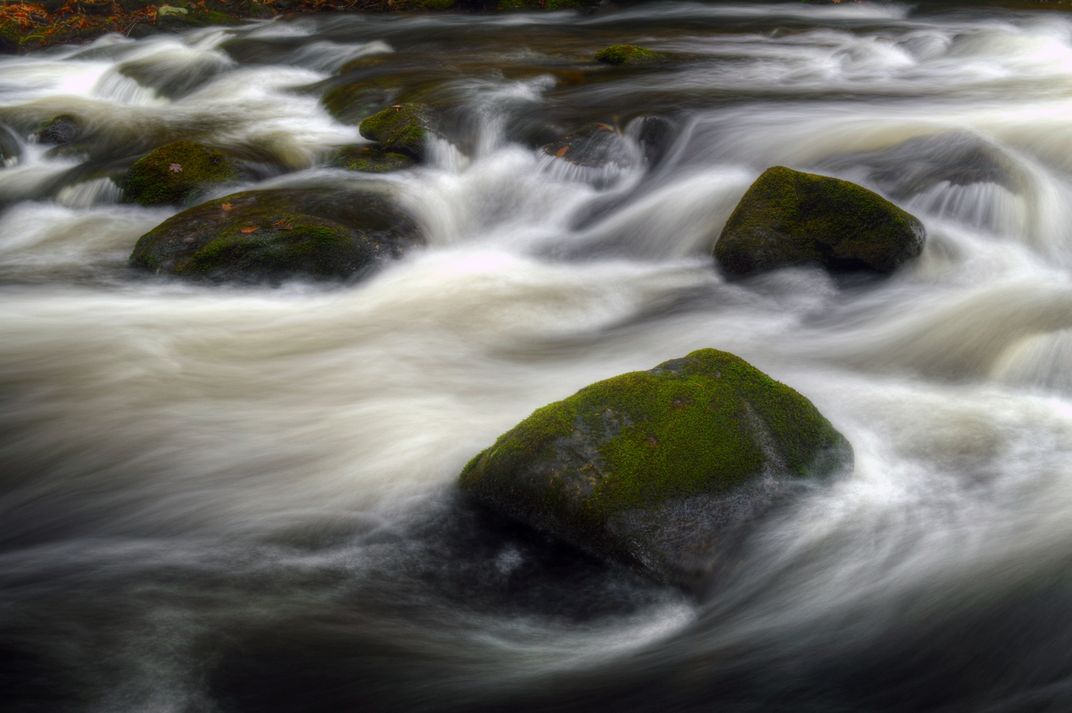 Water rushes over and around the rocks at Fall River, Otis ...