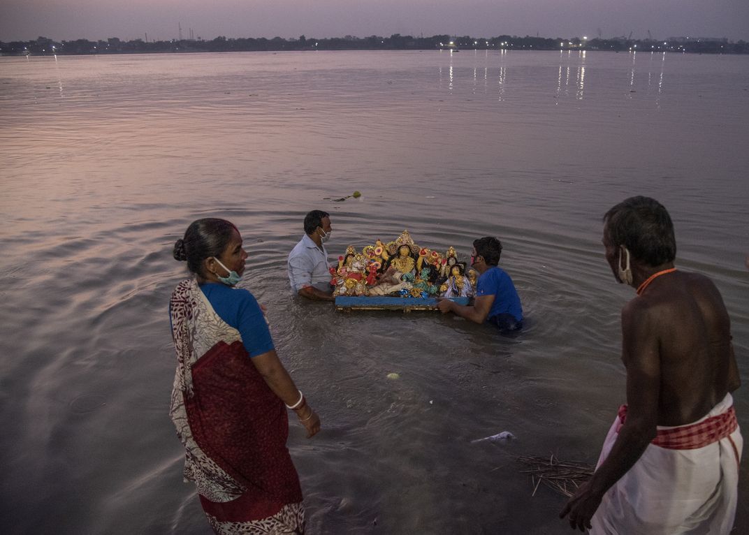 Devotees at Ganga river, performing immersion of Goddess Durga ...