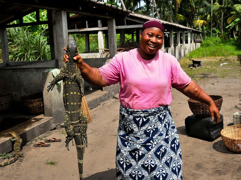 A female fishmonger shows off her prized possession. African Nile ...
