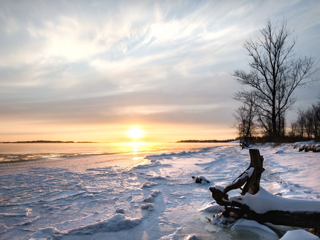 A cold winter sunset across the frozen river | Smithsonian Photo ...
