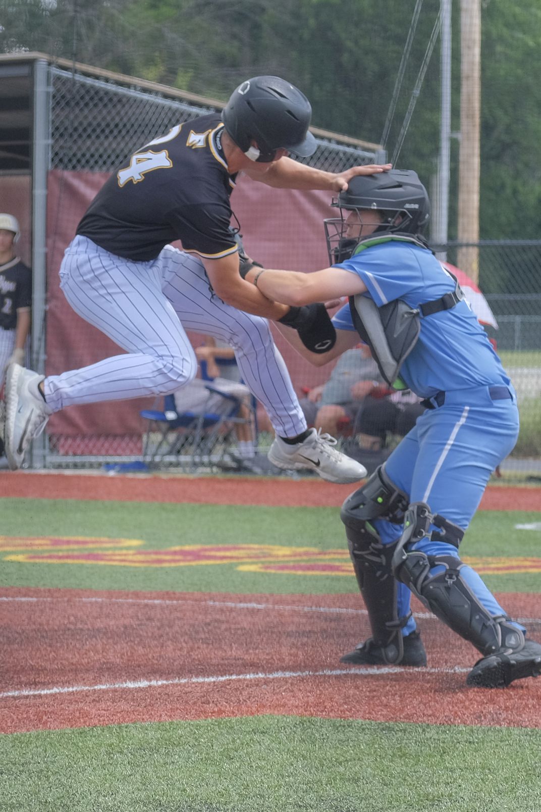 Catcher tags jumping runner out at home plate. | Smithsonian Photo ...