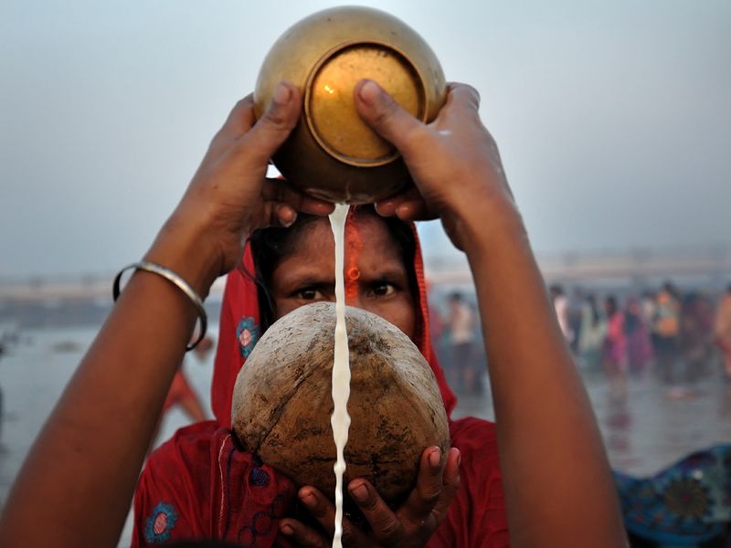 A woman performing religious ritual in the chhat festival,a major ...