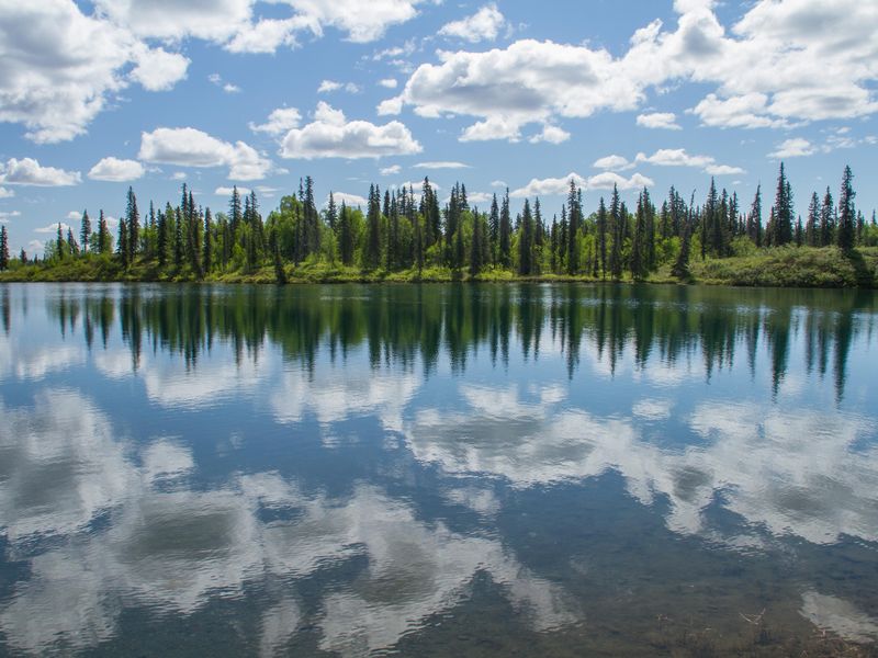 Clouds reflected in the twin lakes near Dillingham, Alaska ...