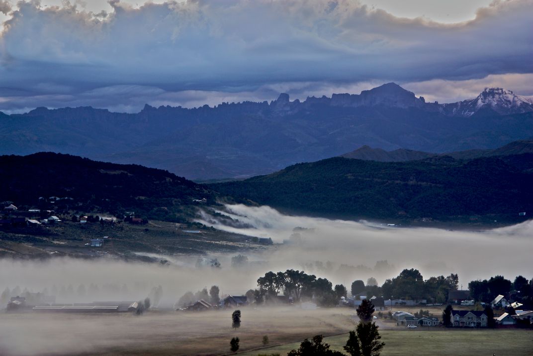 Fog veils the town of Ridgeway in Colorado's San Juan Mountains ...