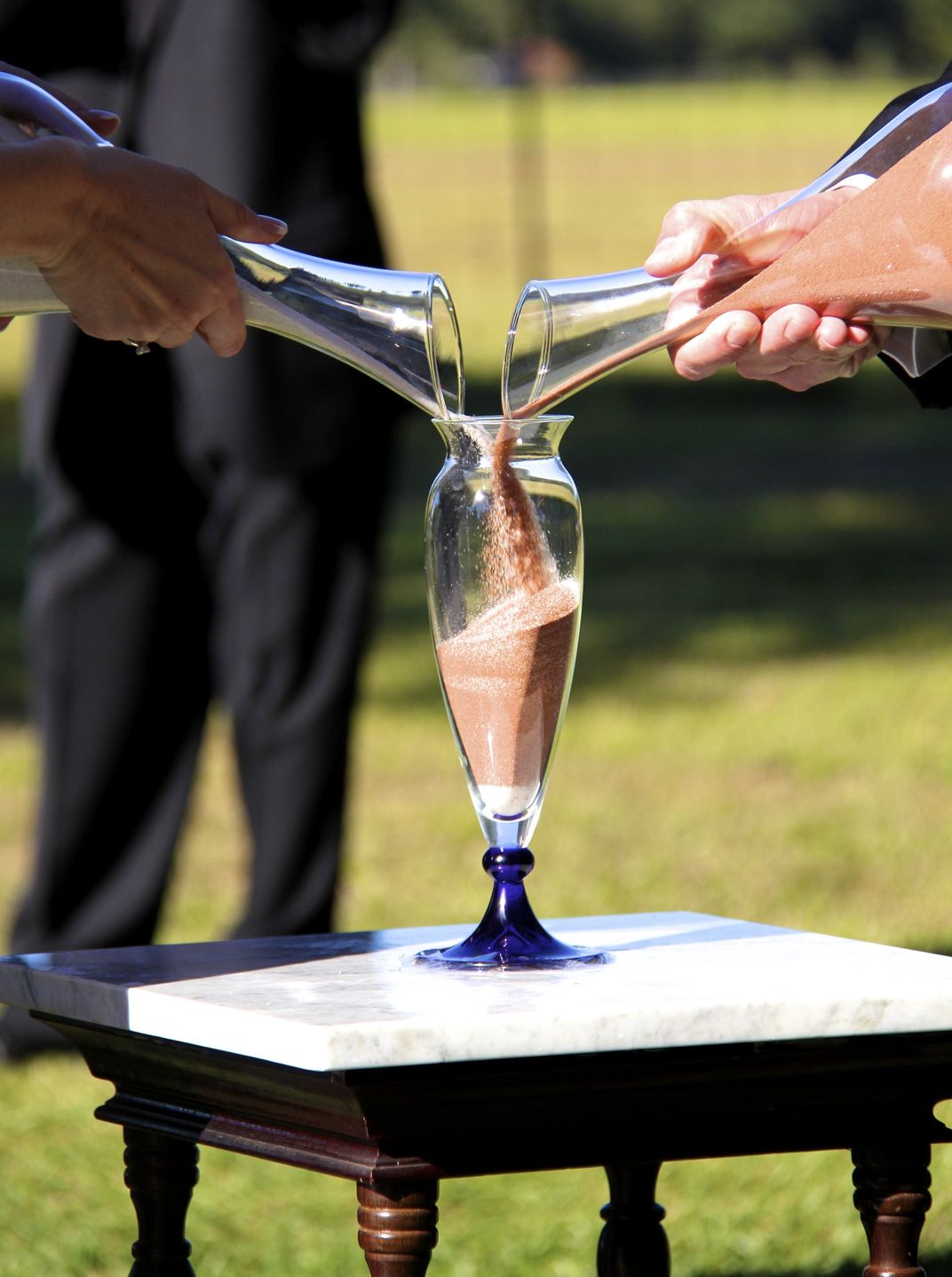 Sand from the Dead Sea and sand from Mali, Africa being poured together ...