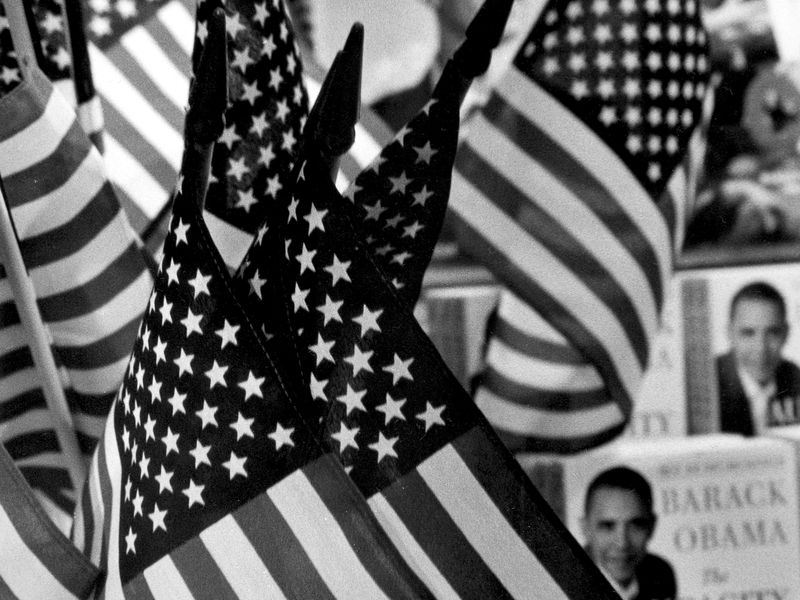 American flags with the image of President Obama in the background ...
