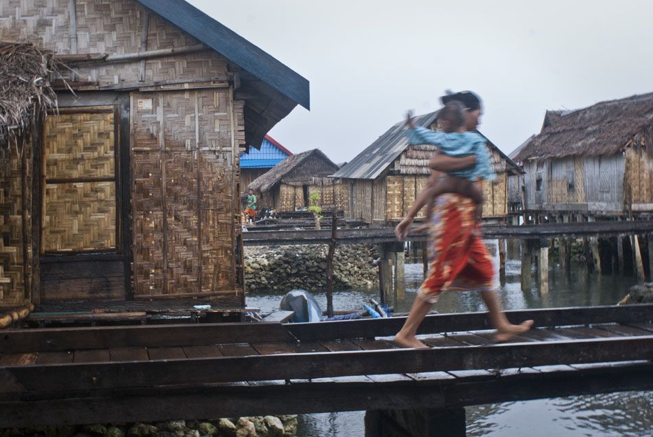 A young mother from Sampela, Indonesia, a once "sea gypsy" community ...