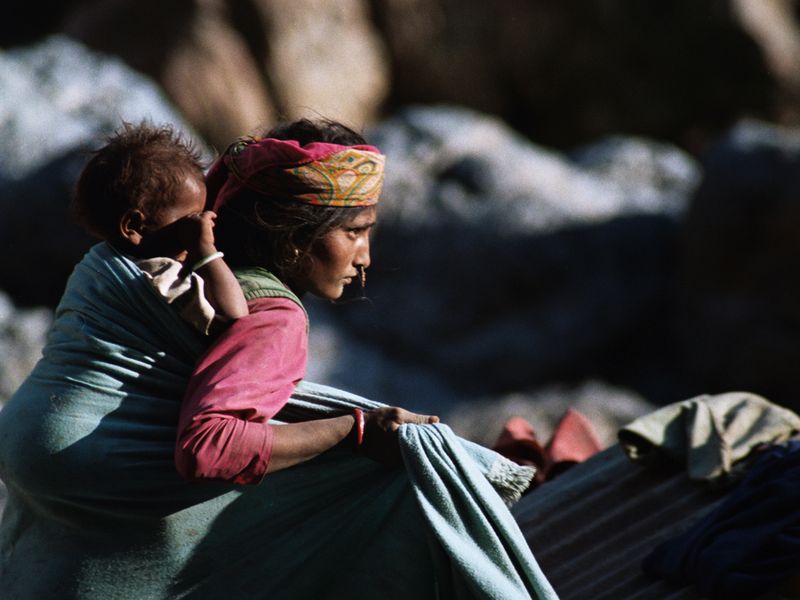 A woman was going to breaking stones.She carries her child and could ...