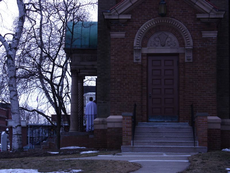 A priest waiting standing outside his church | Smithsonian Photo ...