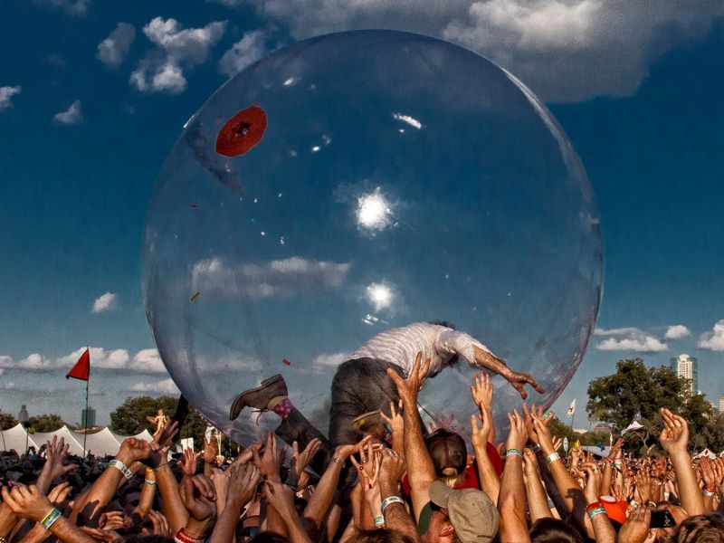 Performer inside giant inflatable ball at concert | Smithsonian Photo ...