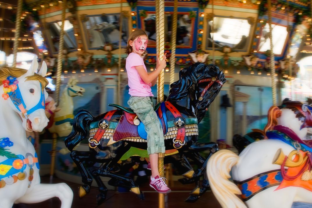 Girl with painted face on state fair carousel. | Smithsonian Photo ...