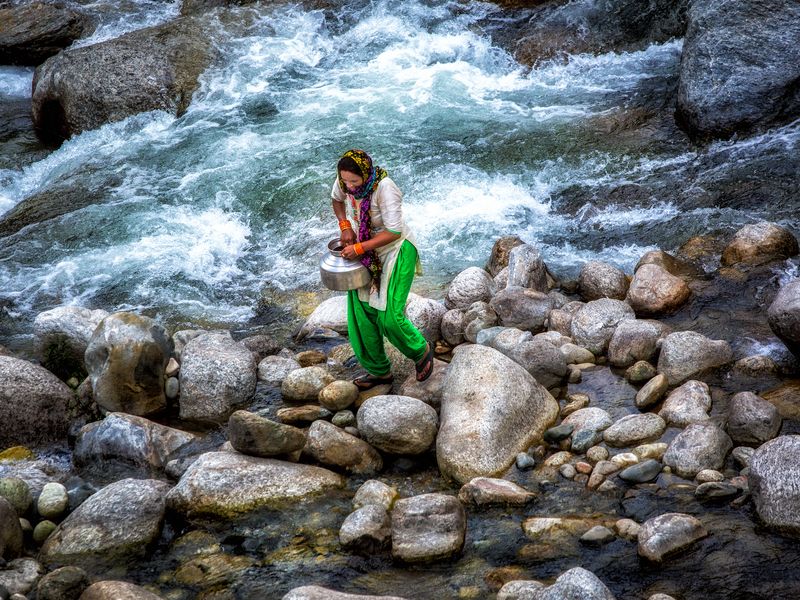 Woman fetching water from Balganga River at Budhakedar, Uttarakhand ...