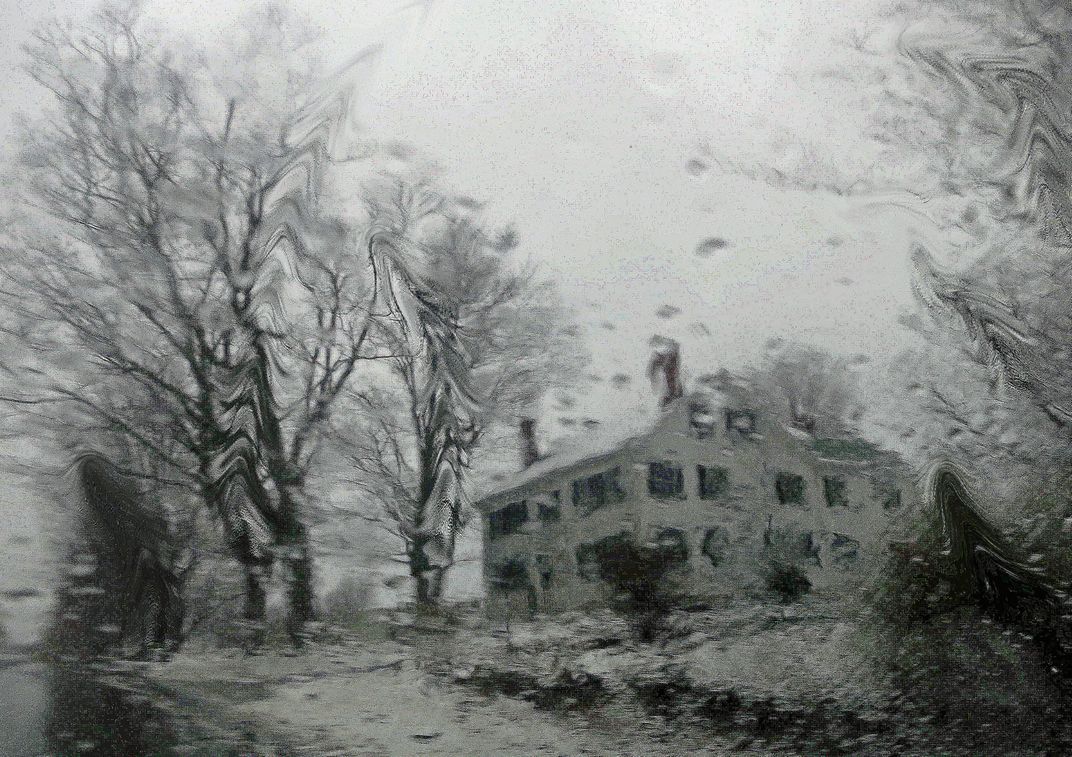 House in stormy weather distorted naturally (rain on car window) and ...