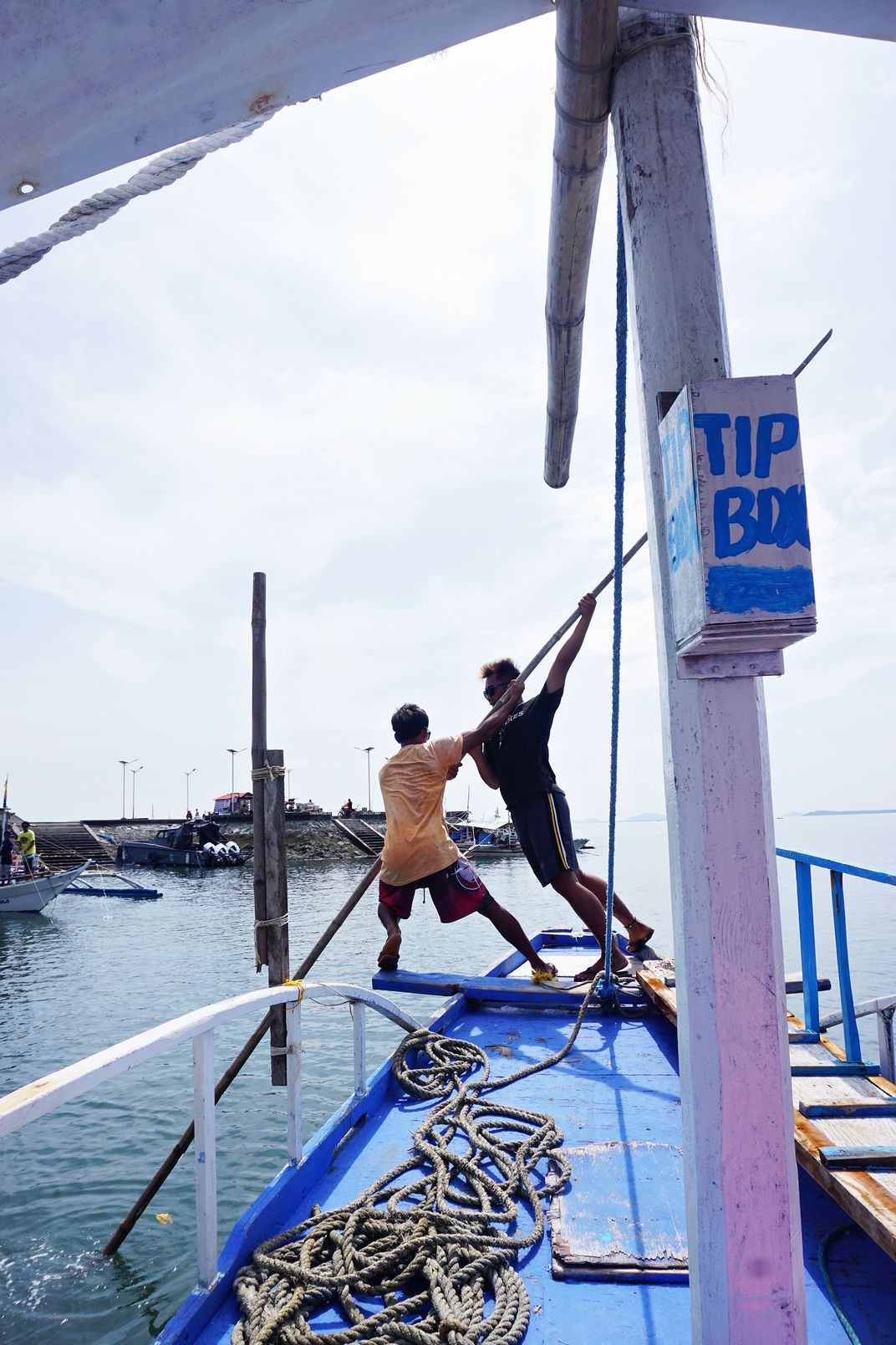 Two men moving the boat out into the water | Smithsonian Photo Contest ...