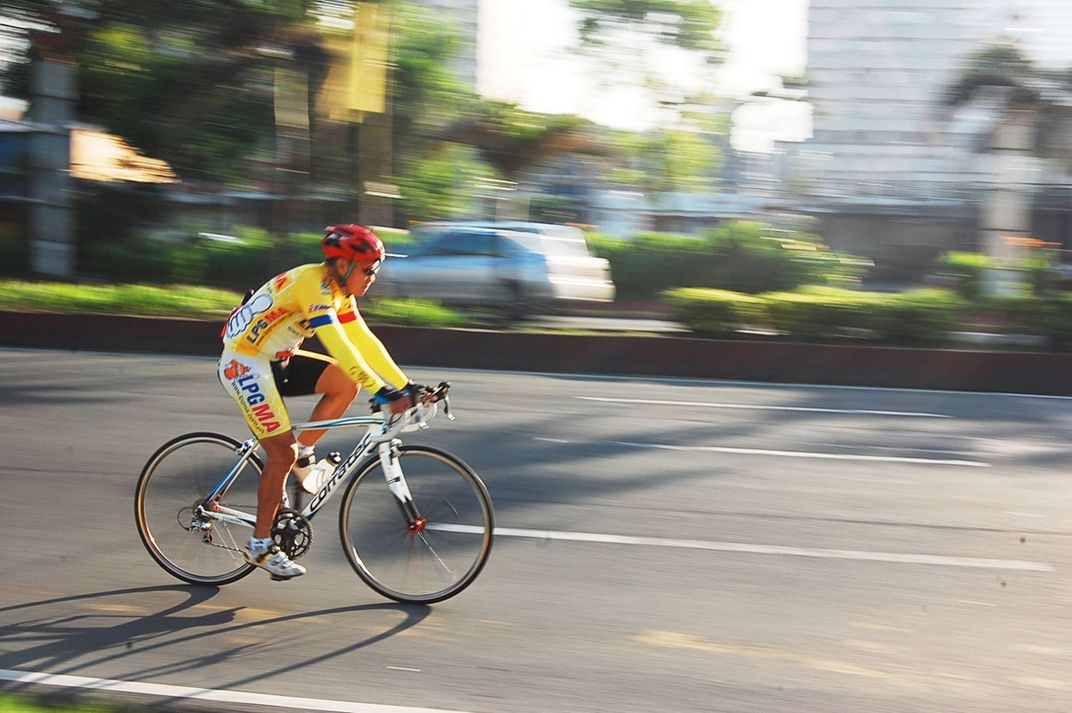 A man cycling along the streets of Manila Bay, Philippines ...