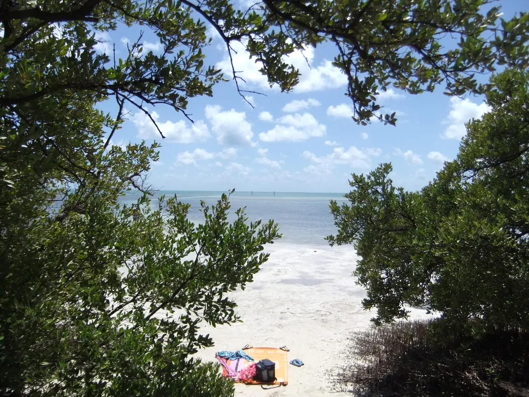 Placid low tide at Annies Beach with channel markers in distance ...