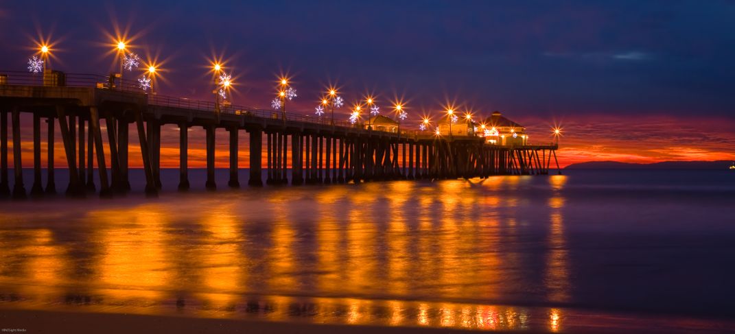 A sunset shot of Huntington Beach Pier during a winter sunset ...