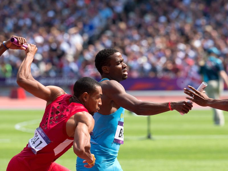 Simultaneous passing of two relays during a men relay race at the 2012 ...