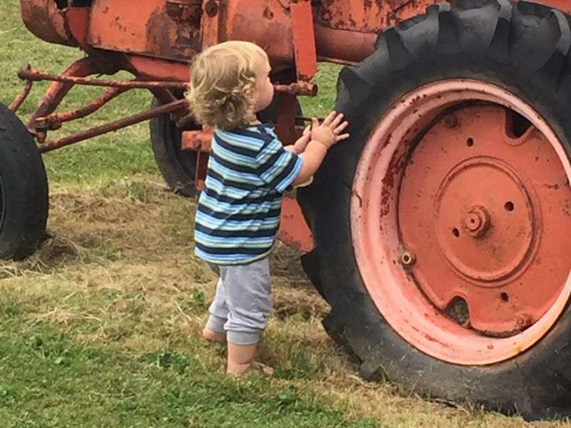 A baby and a tractor | Smithsonian Photo Contest | Smithsonian Magazine