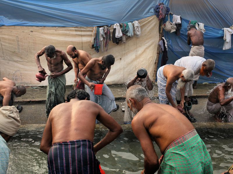 Men are having shower in the world congregation of Muslims. After Hajj ...