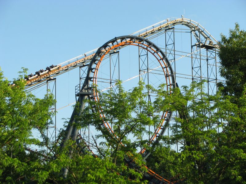 A roller coaster train ascends toward the top of the hill, ready to ...