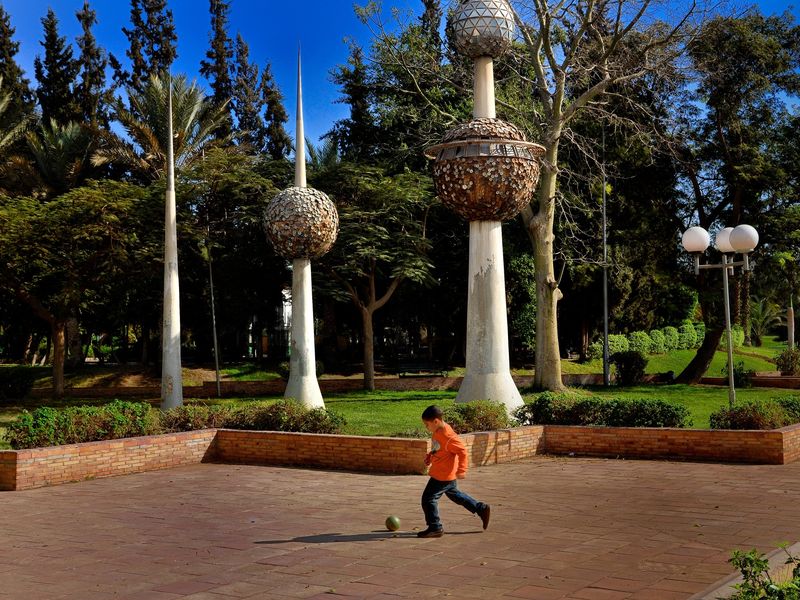 A young boy plays ball at International Park in Cairo, Egypt ...