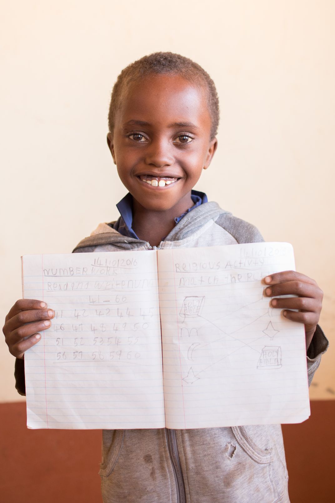 5 year old Metui Kelow, showing his morning class assignment ...