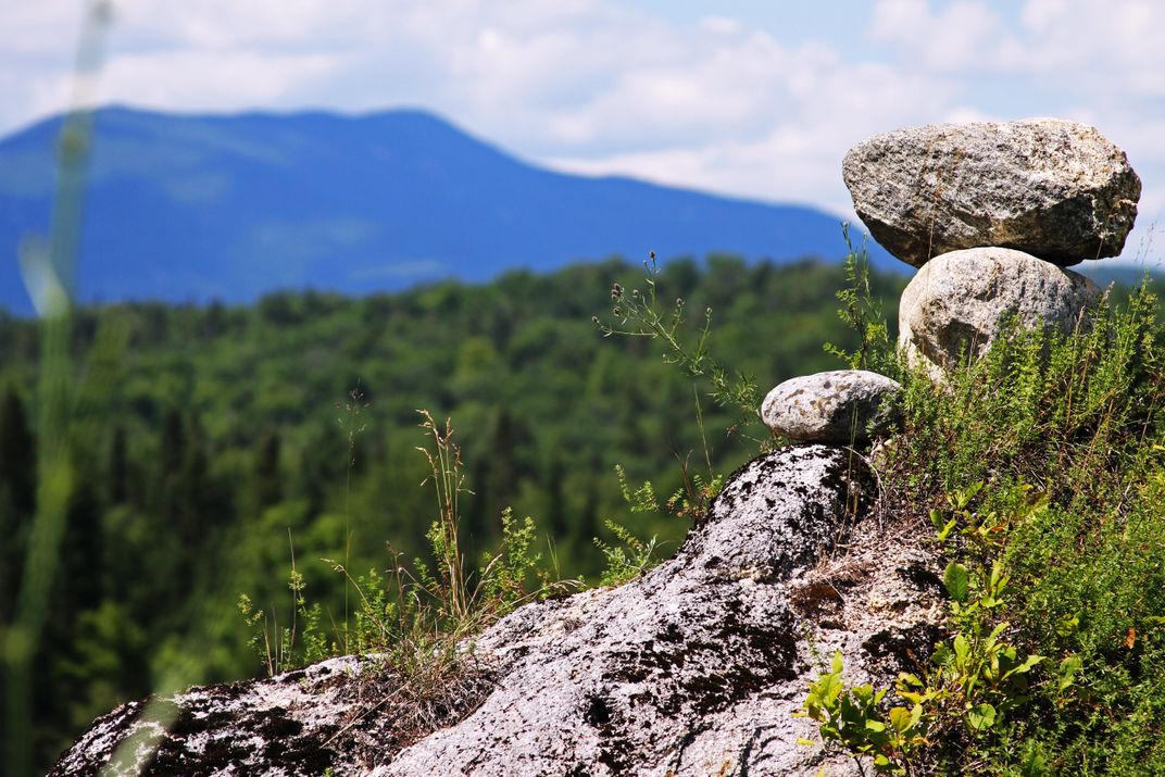 Stacked rocks with the Adirondack Mountains in the background ...