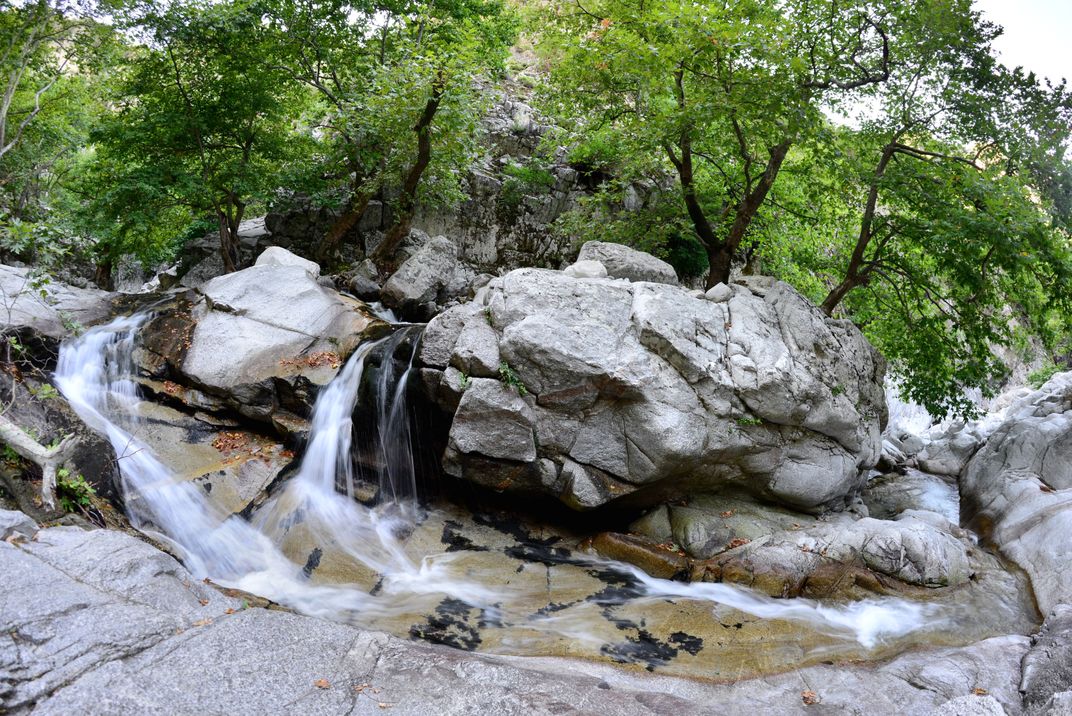 Two waterfalls join the same river on the rocks of Samothraki ...