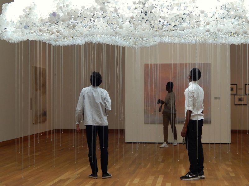 An interactive exhibit of incandescent light bulbs at an art museum ...