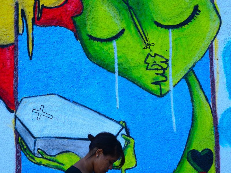 Sad woman walks, combining with graffiti painted on the wall ...